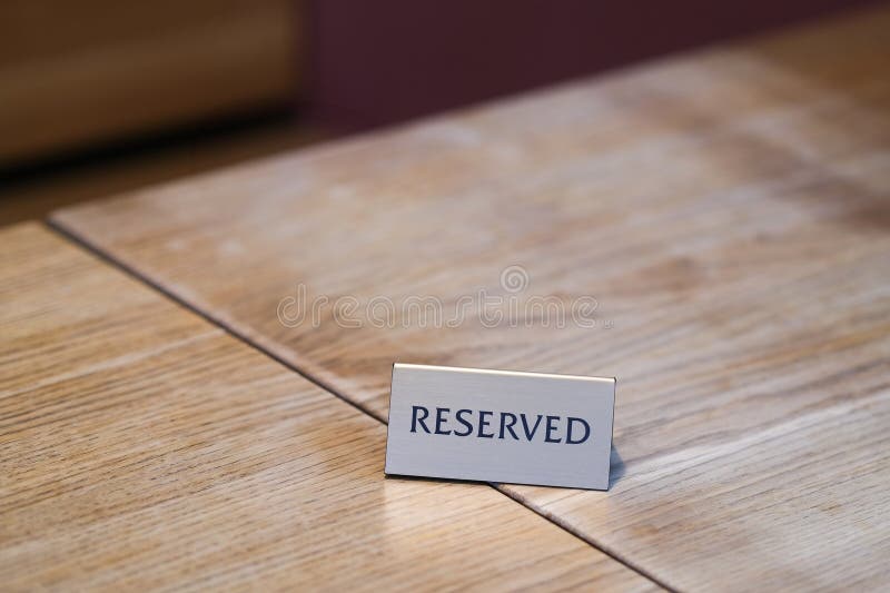 Reserved sign on a table stock photo. Image of metal - 362090638