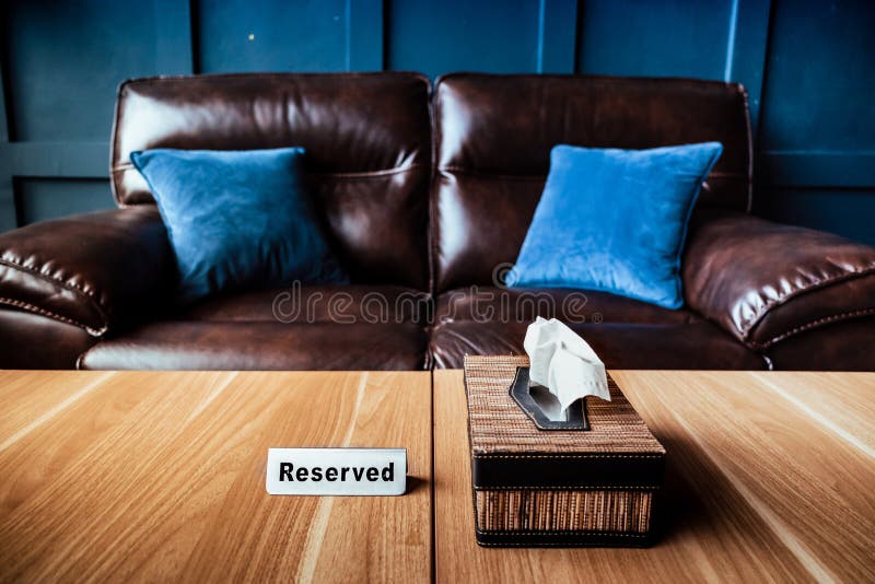 A Reserved Table at Restaurant with Leather Sofa and Blue Cushions on ...