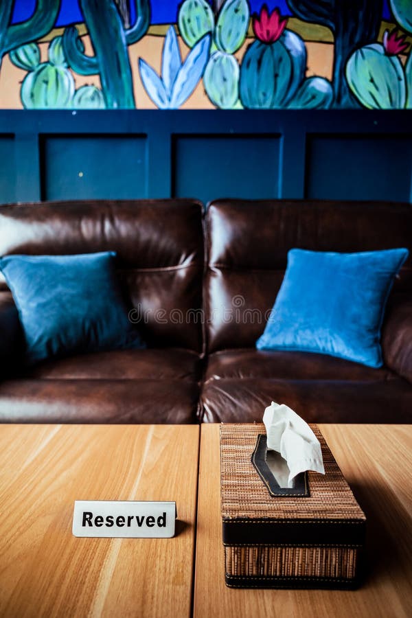 A Reserved Table at Restaurant with Leather Sofa and Blue Cushions on ...