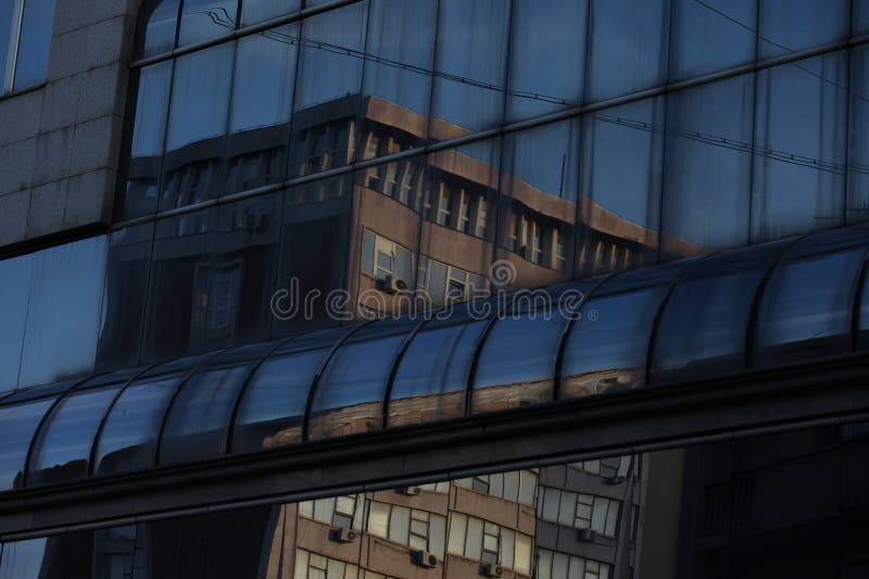 A Residential Building Reflected on Another Building with Large Windows ...