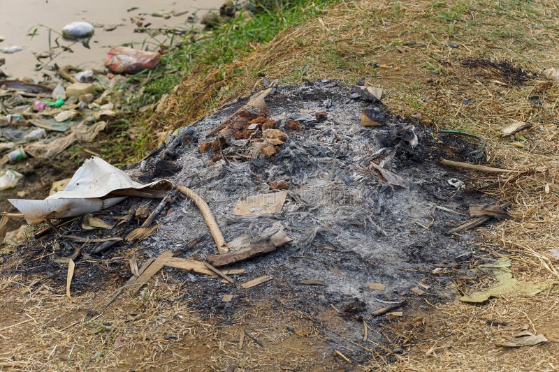 Residue from Burning Garbage on the Grass Near the River Stock Image ...