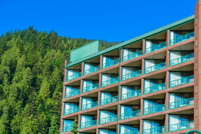 Resort Building Facade on Mounting and Blue Sky Background Stock Photo ...