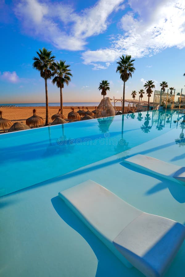 Resort Infinity Pool in a Beach with Palm Trees Stock Image - Image of ...