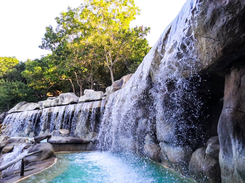 Waterfall and Swimming Pool in Front of a Hotel Stock Photo - Image of ...