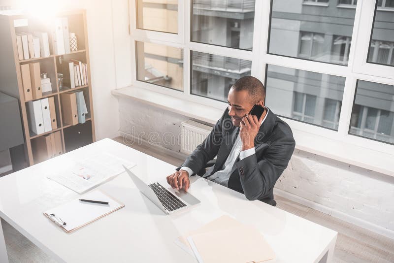 Respectable Businessman Speaking on Smartphone while Operating by ...
