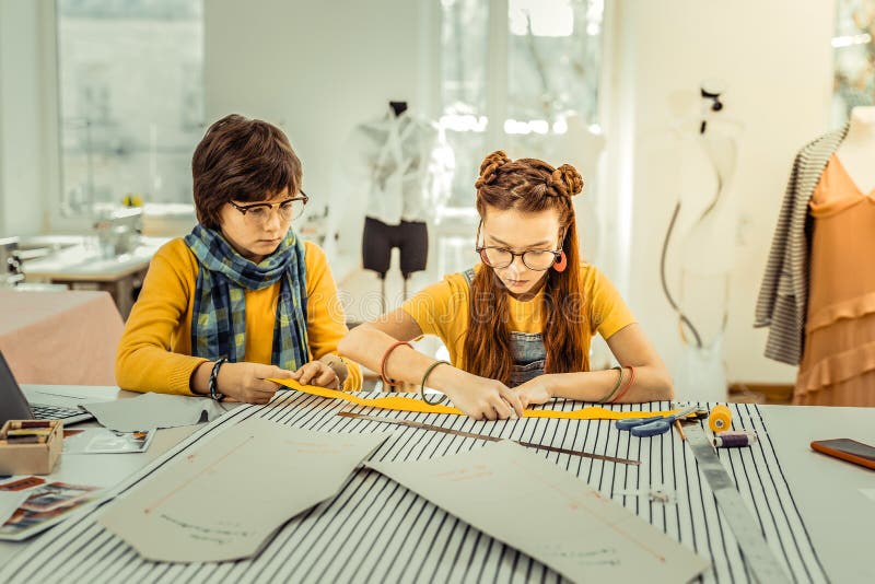 Children Helping Their Mother Who is Designer To Draft Patterns Stock ...