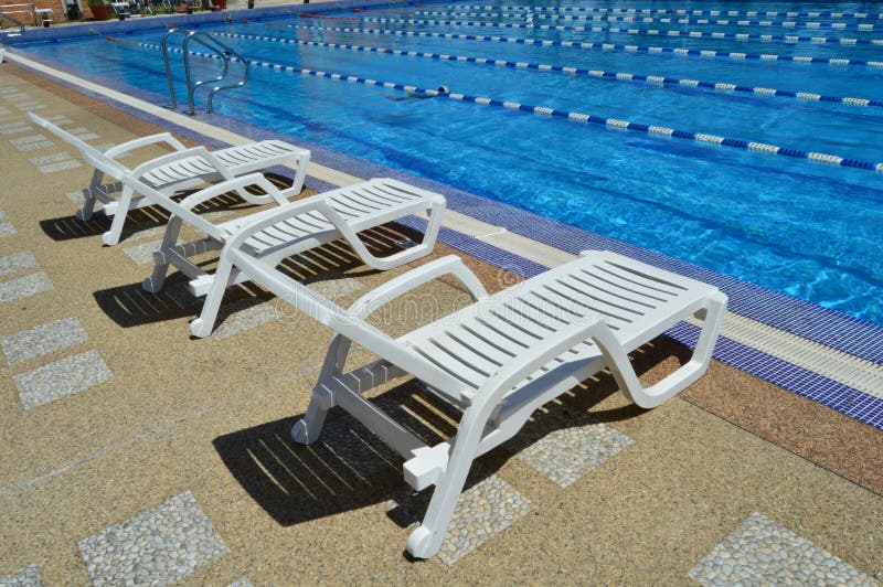 Rest chairs by the pool. stock photo. Image of blue, water - 58955702