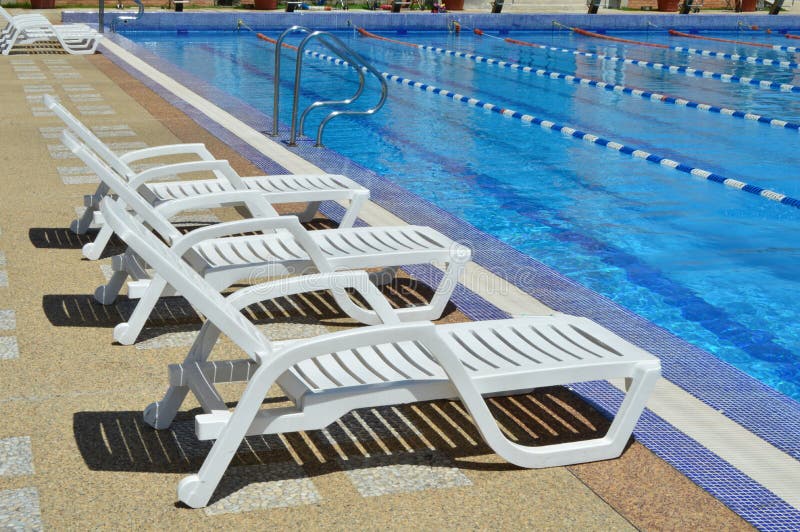 Rest chairs by the pool. stock image. Image of used, water - 58956435