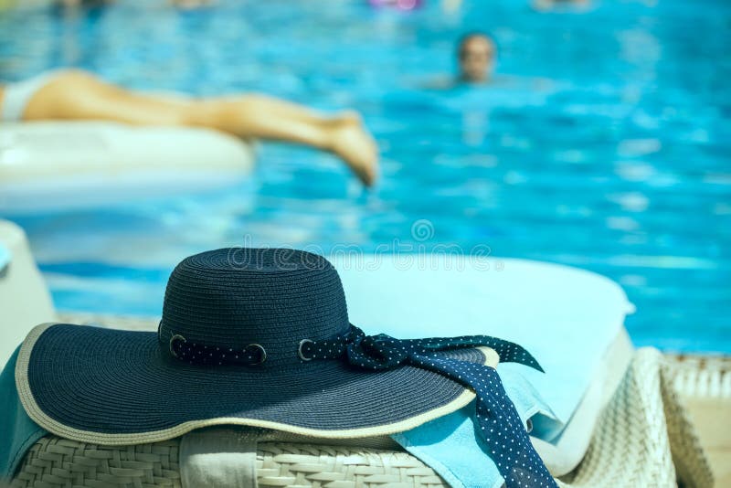 Rest in the Pool. a Hat on a Sun Lounger and People in the Water Stock ...