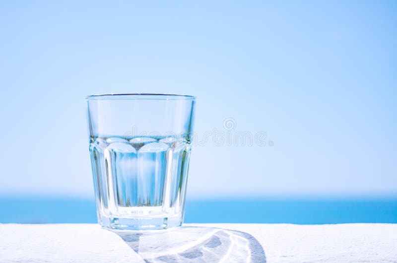Rest on the Sea. Empty Glass Cup on the Background of the Sea Stock ...