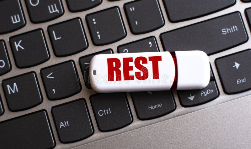REST - the Word on a White Flash Drive, Lying on a Black Laptop ...