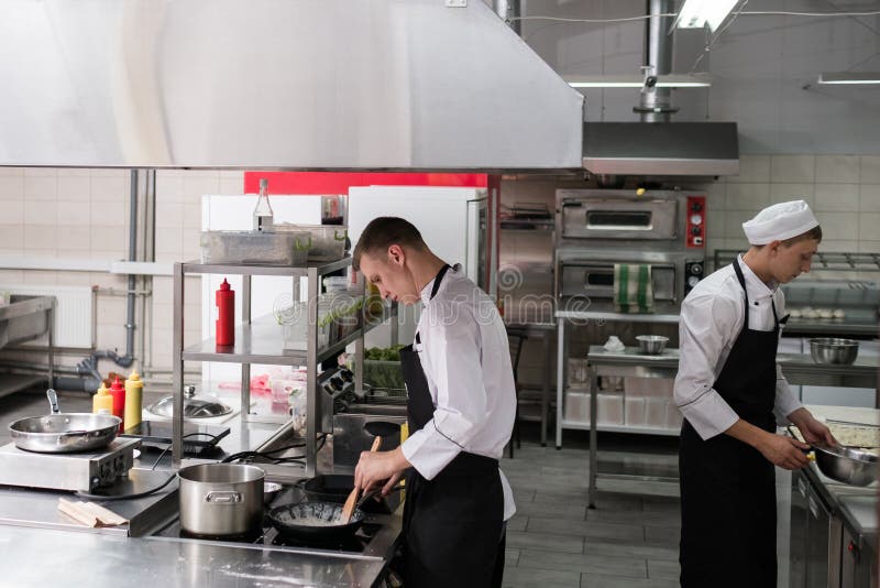 Two Male Cook Work in Professional Kitchen Stock Photo - Image of ...