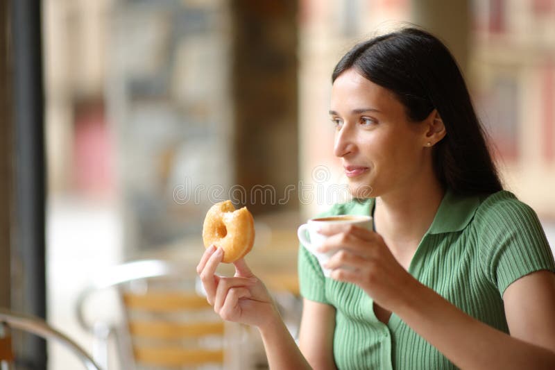 Restaurant Customer at Breakfast Eating Doughnut and Drinking Stock ...