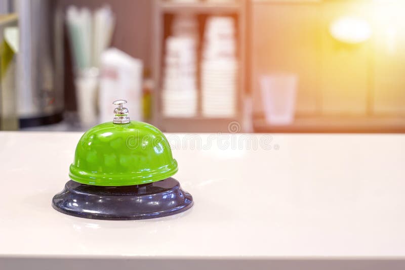 Restaurant Green Bell with Bokeh on White Table Stock Image - Image of ...