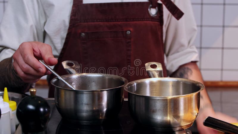 Restaurant Kitchen - the Chef Making Sauce for the Meal with Meat Stock ...