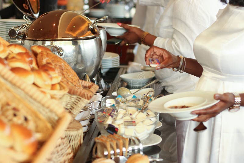 Restaurant Kitchen with Chefs Preparing Food Behind a Table with Bread ...