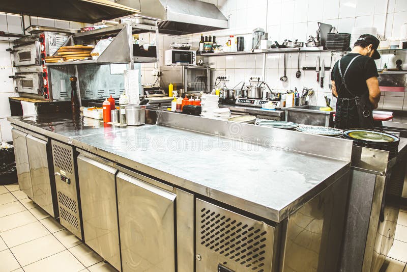Restaurant Kitchen Interior. Cooking Area and Chef Preparing the Dish ...