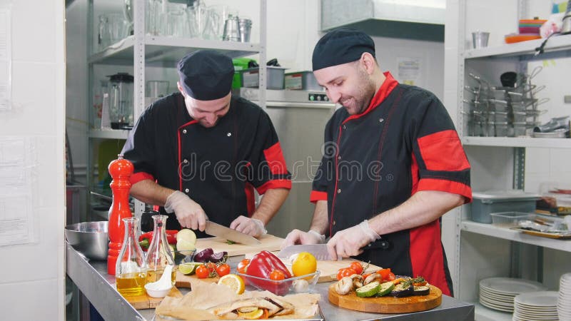 Restaurant Kitchen. Two Men Working on Serving Dishes Stock Image ...