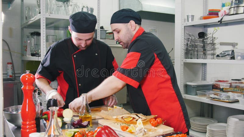 Restaurant Kitchen. Two Men Working on Serving Dishes Stock Image ...