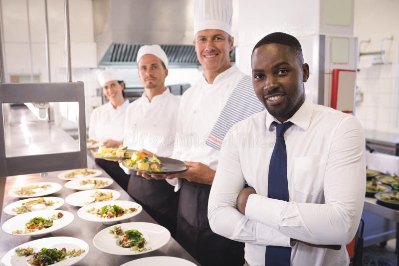 Restaurant Manager Posing in Front of Team of Staff Stock Image - Image ...