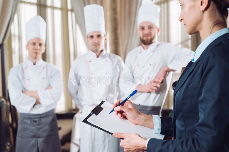 Restaurant Manager and His Staff in Kitchen. Interacting To Head Chef ...