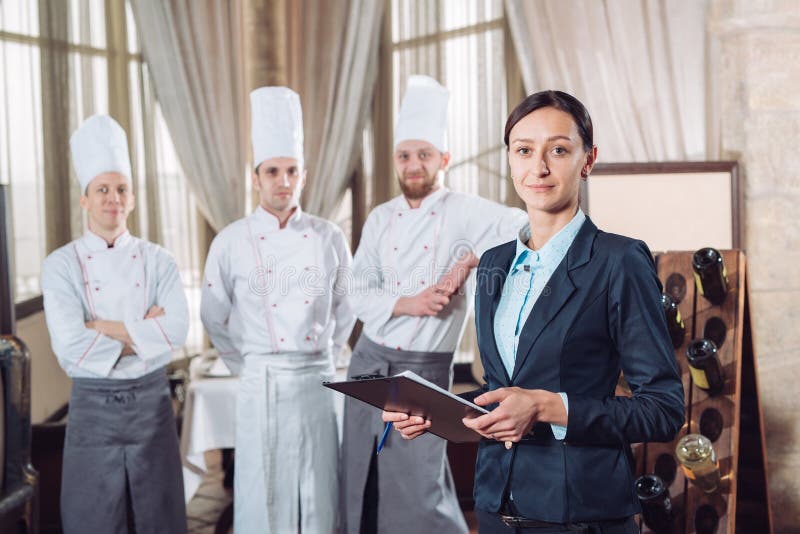 Restaurant Manager and His Staff in Kitchen. Interacting To Head Chef ...