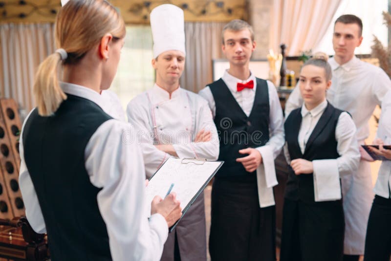 Restaurant Manager and His Staff in Kitchen. Interacting To Head Chef ...