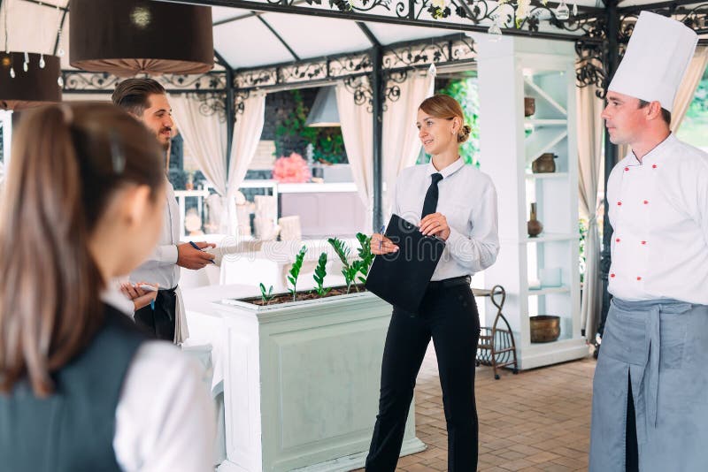 Restaurant Manager and His Staff in Terrace. Interacting To Head Chef ...