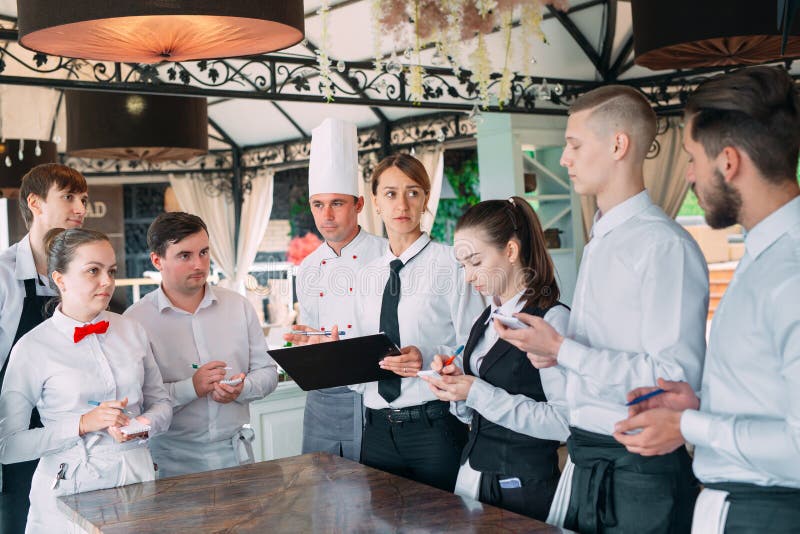 Restaurant Manager and His Staff in Terrace. Interacting To Head Chef ...