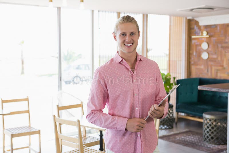 Restaurant Manager Holding Clipboard Stock Photo - Image of chair ...