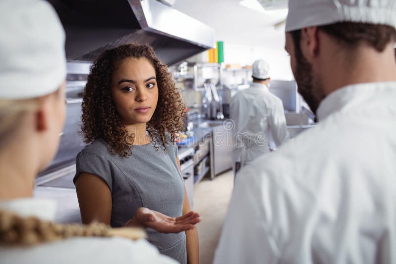 Restaurant Manager Interacting with His Kitchen Staff Stock Photo ...