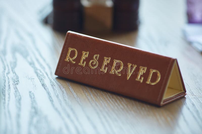 Restaurant Reserved Table Sign. a Brown Reserved Sign is on the Table ...