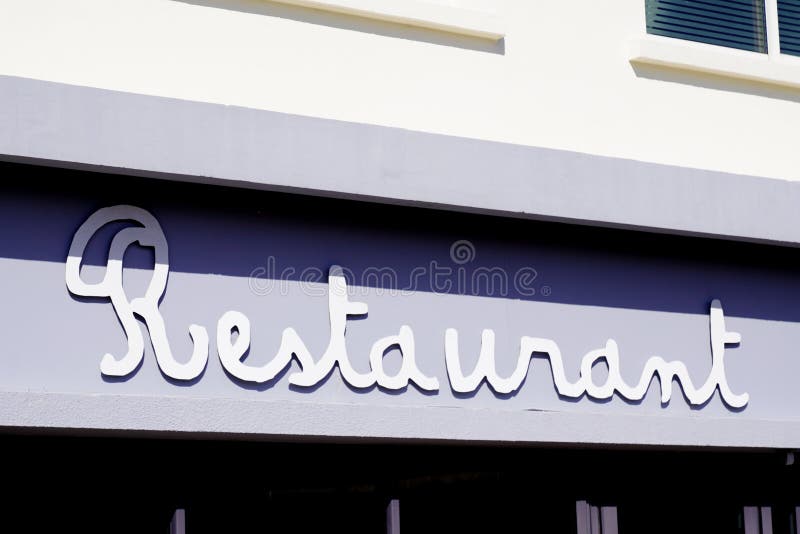 Restaurant Text Sign on Grey Facade Building City Street Storefront ...