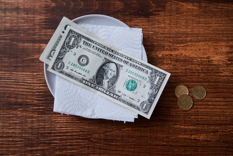 Restaurant Tips or Gratuity. Banknotes and Coins on a Plate Stock Image ...