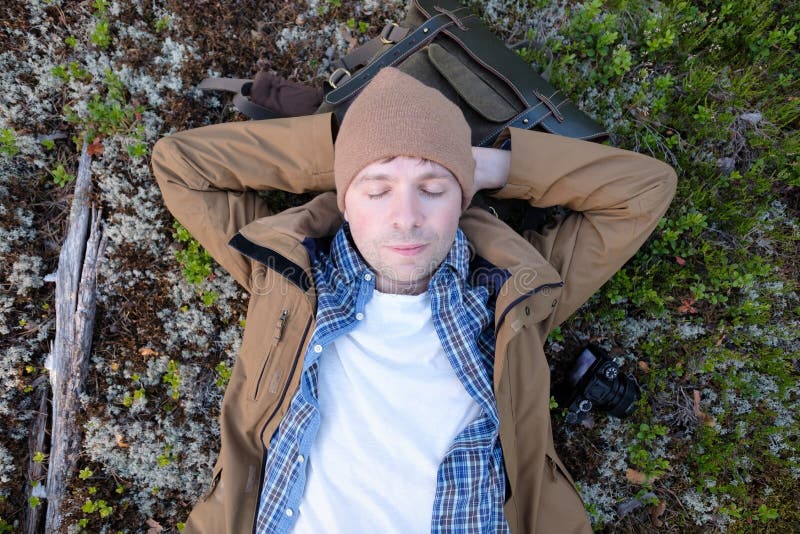 Restful Young Man Laying Down on the Ground of a Forest or a Park Stock ...