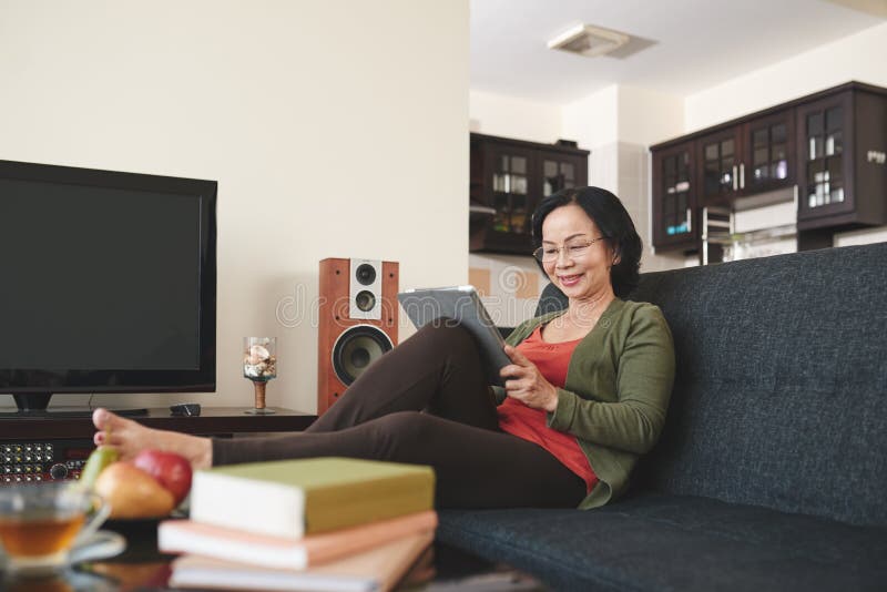 Restin on couch stock image. Image of woman, tablet, sofa - 89119897
