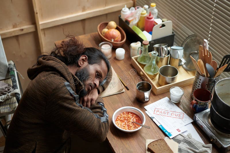 Resting Man Leaning on Table beside Food in Rustic Setting Stock Image ...