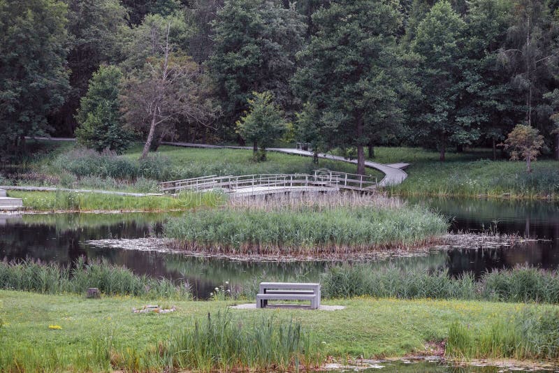 .a Resting Place with a Bench in the Park between the Water and the ...