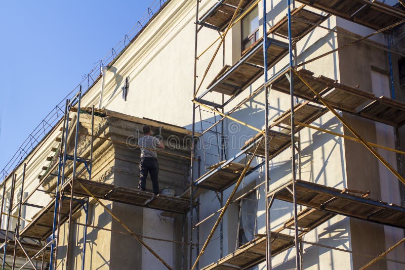 Restoration Work on an Old Building. Builder on Scaffolding Stock Image ...