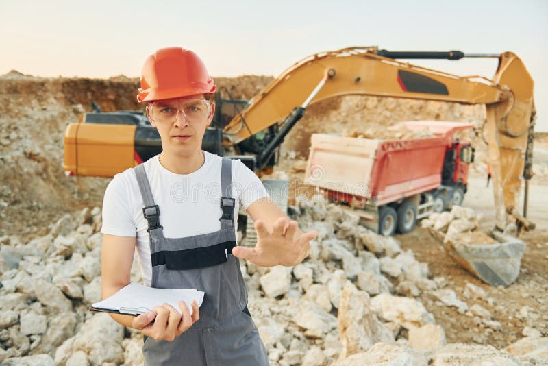 Restricted Area. Worker in Professional Uniform is on the Borrow Pit at ...