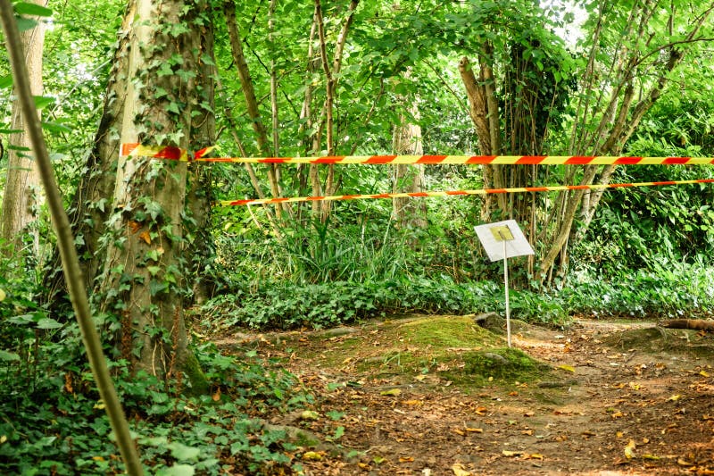 Restricted Forest Area with Warning Tape and Sign in Lush Greenery ...