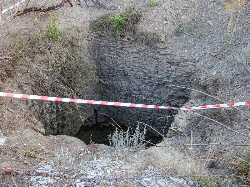 A Restricted, Water-filled Mine or Quarry with Vegetation and Rocks ...