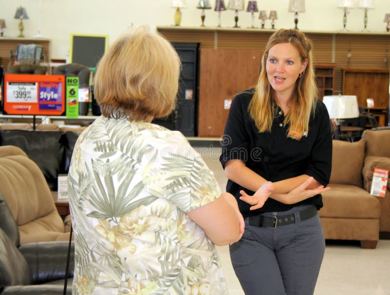 Retail Associate Helping Customer Stock Photo - Image of blond ...
