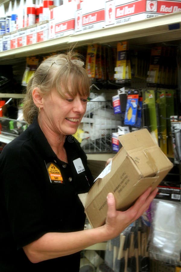 Retail Associate Putting Out Stock Stock Image - Image of helping ...