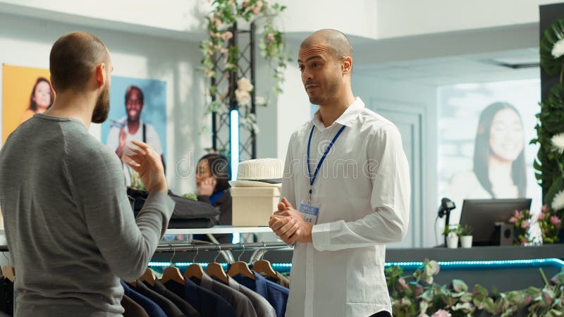 Retail Store Worker Assisting a Young Man Client with Style Advice ...