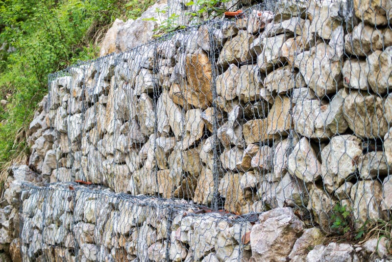 Retaining Stone Wall Next To the Road.Steel Mesh of Gabion Wall Stock ...