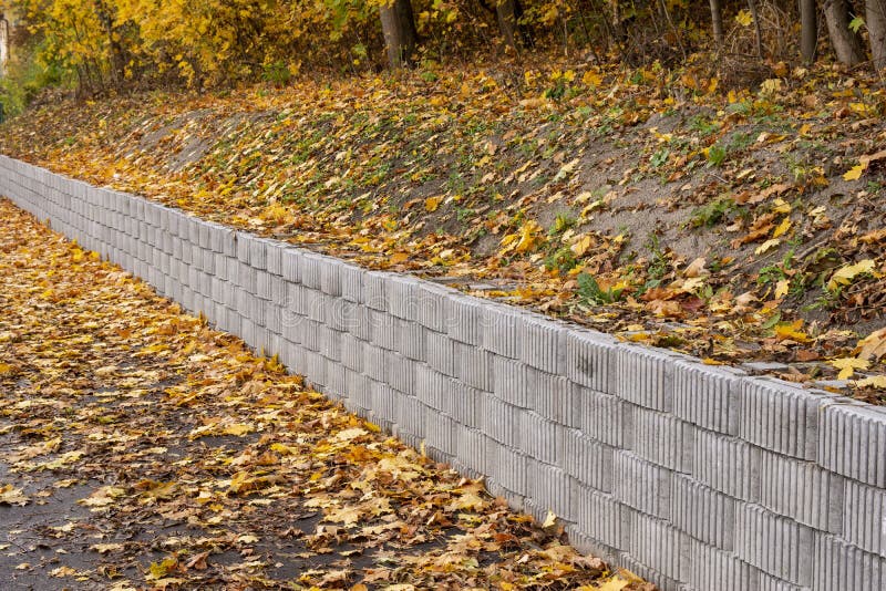 A Retaining Wall Made of Concrete Elements Protects the Roadway and ...