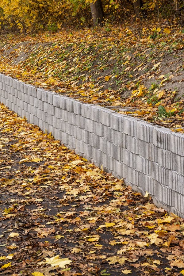 A Retaining Wall Made of Concrete Elements Protects the Roadway and ...