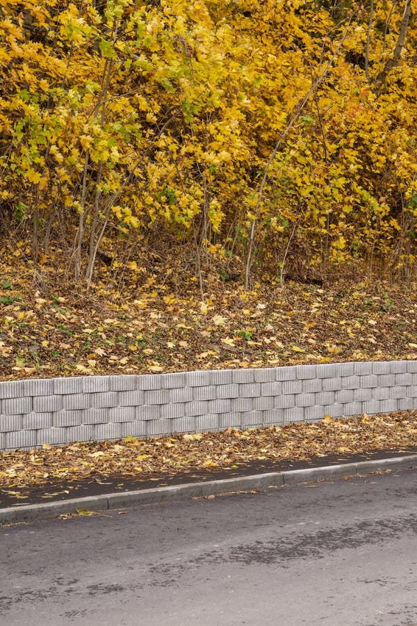 A Retaining Wall Made of Concrete Elements Protects the Roadway and ...