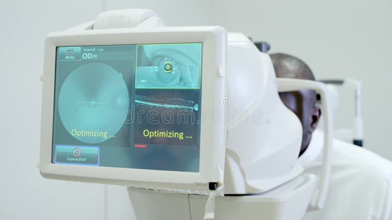 Retinal Exam Performed on a Man Using Optical Coherence Tomography (OCT ...